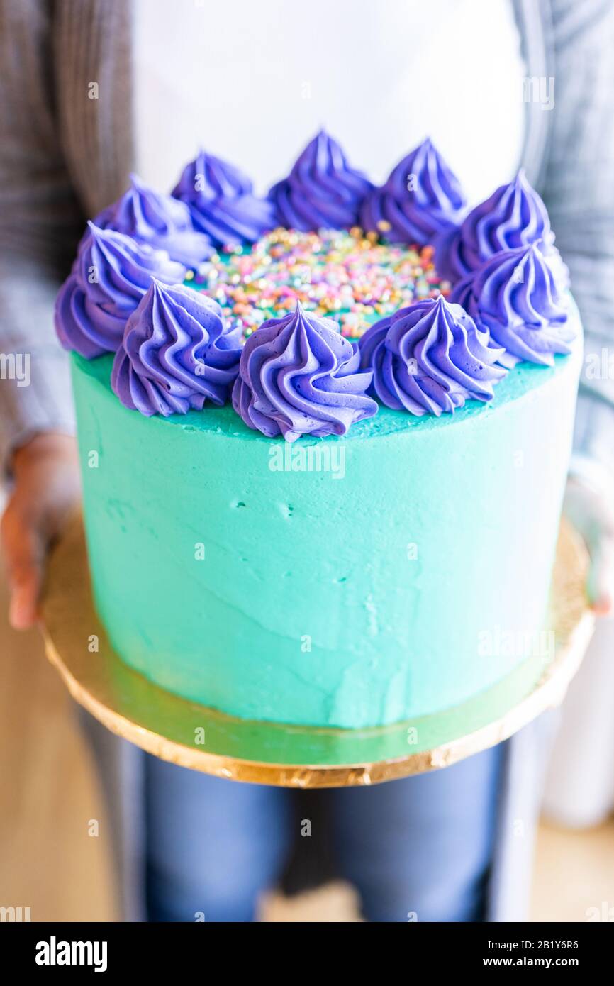 Birthday cake with turquoise buttercream and purple rosettes and ...