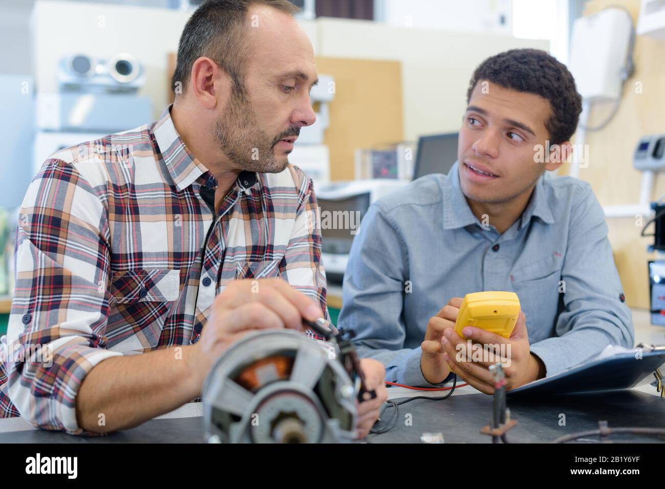 apprentice and teacher in science workshop Stock Photo - Alamy