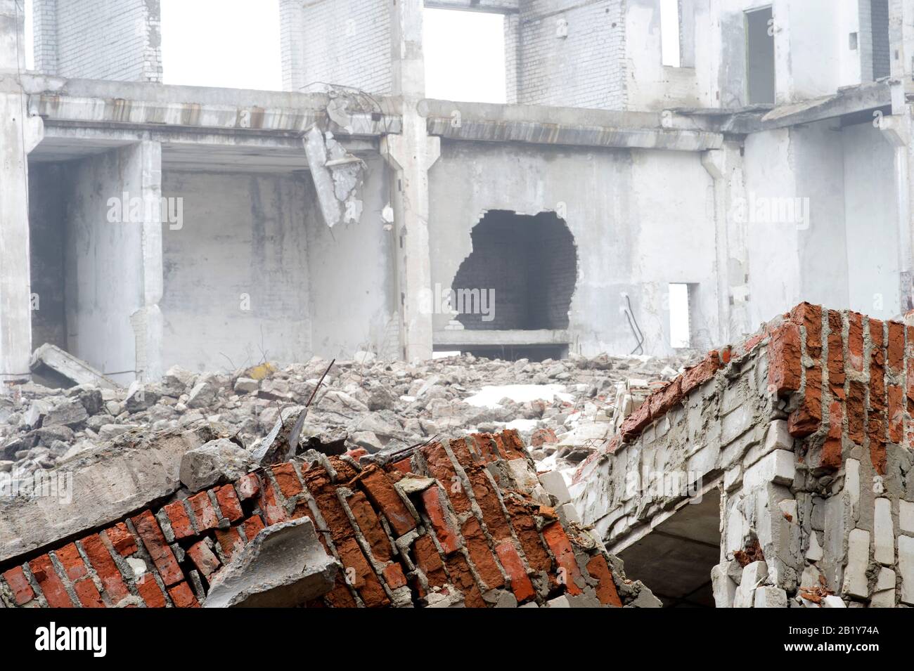 The remains of a large building destroyed in a foggy haze. Background ...