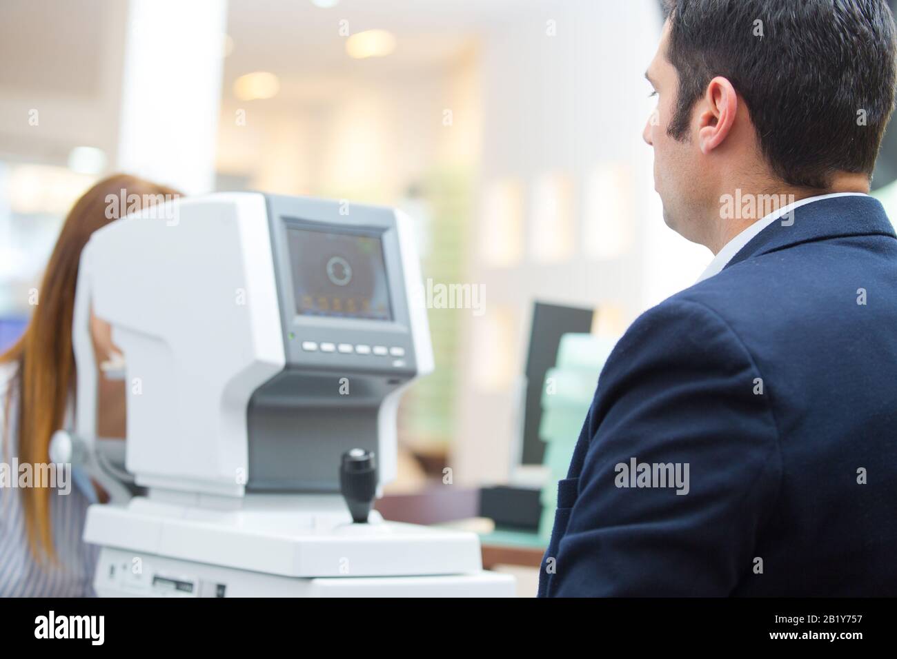 an optician examining patients eyes Stock Photo - Alamy