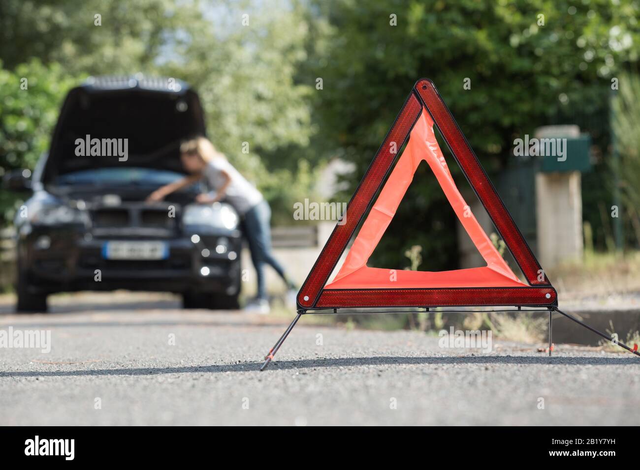 emergency stop sign near broken car on road Stock Photo - Alamy