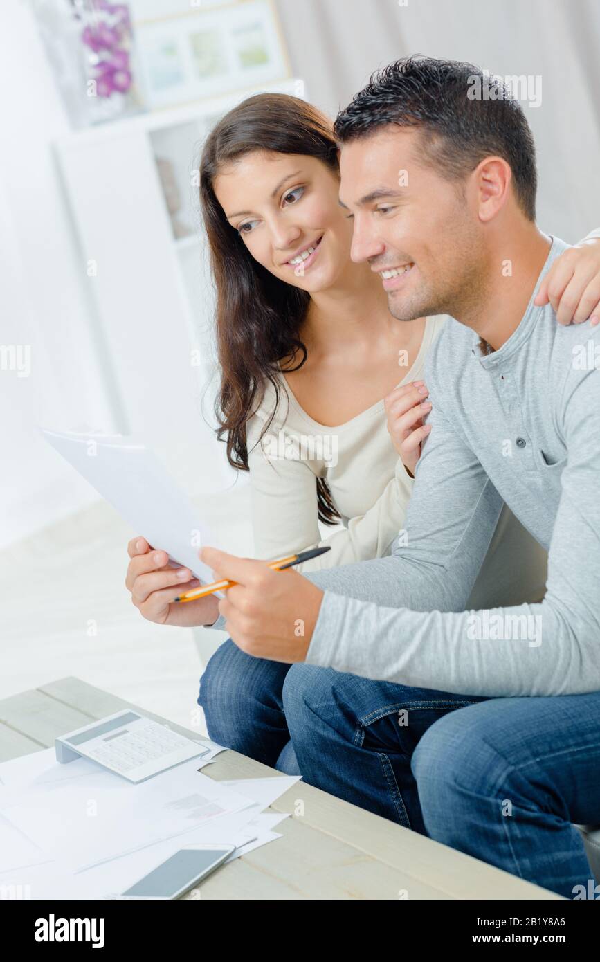 attractive couple doing administrative paperwork Stock Photo - Alamy