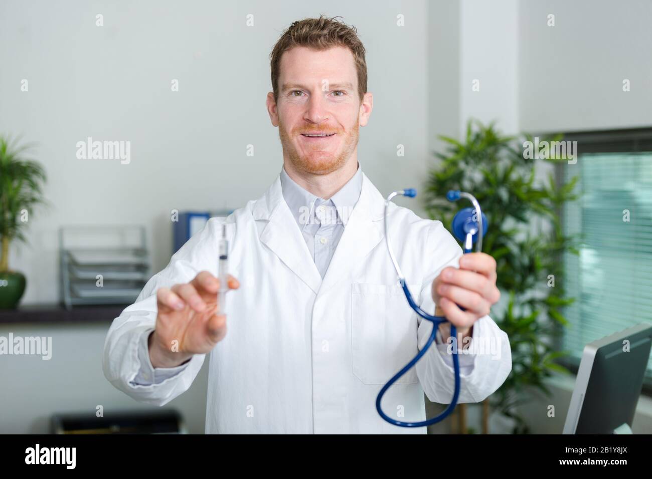 male doctor holding syringe with injection Stock Photo - Alamy
