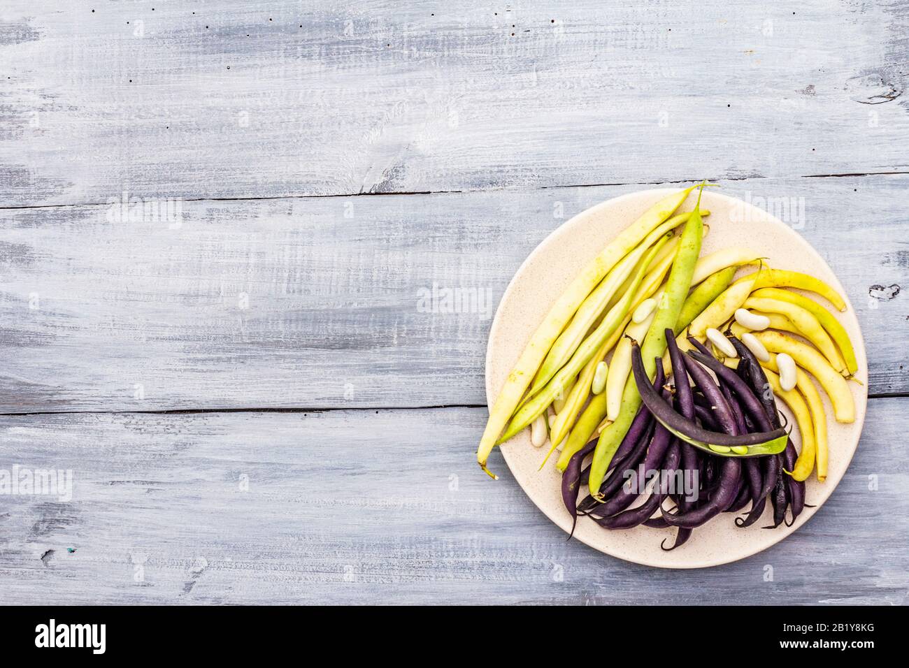 Assorted freshly colored beans in pods. Purple, yellow and green beans ...