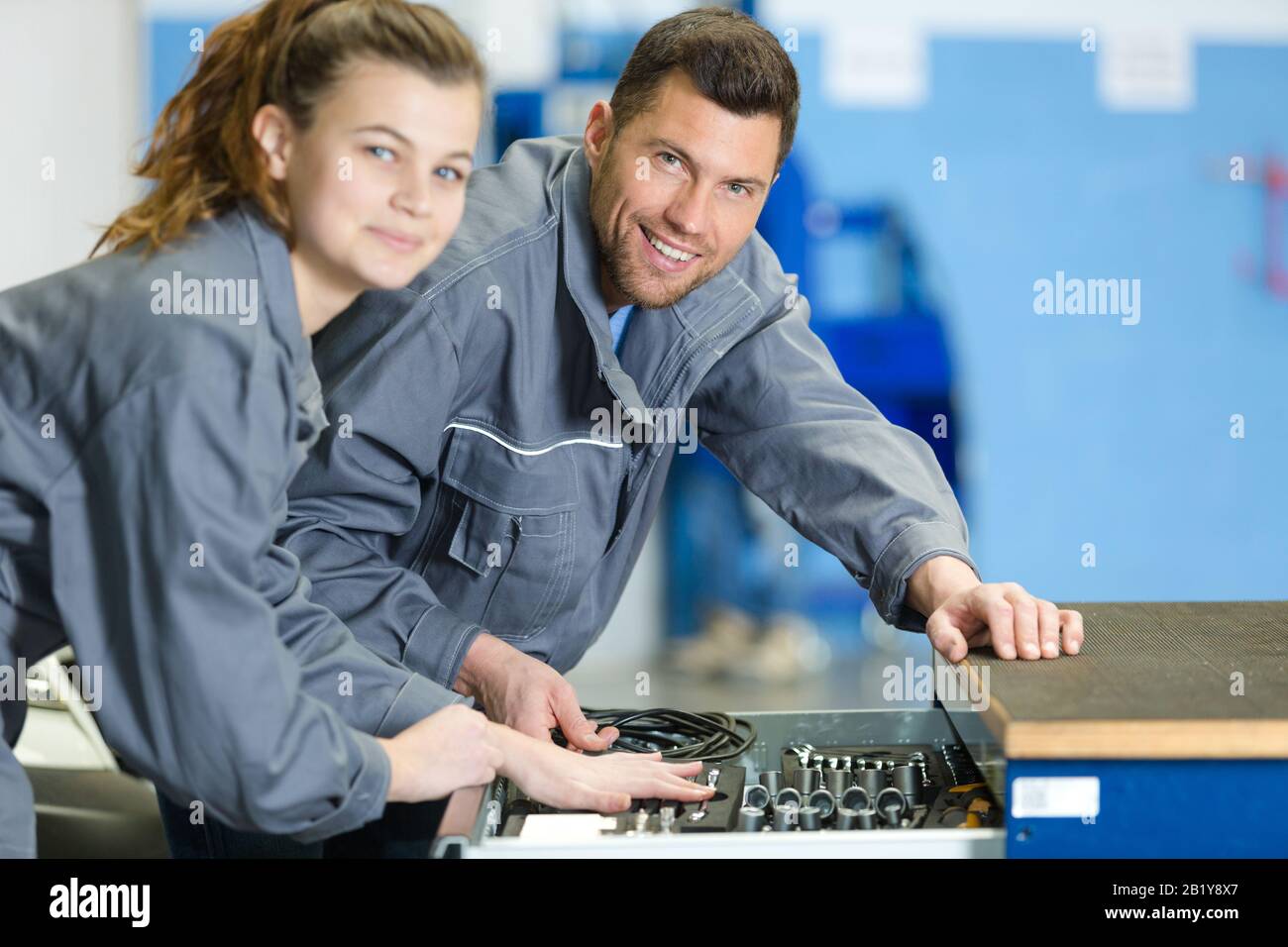 mechanic and apprentice taking a spanner size Stock Photo - Alamy