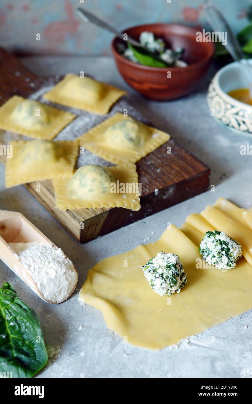 Fresh Raw Ravioli with Ricotta and Spinach on a blue background ...