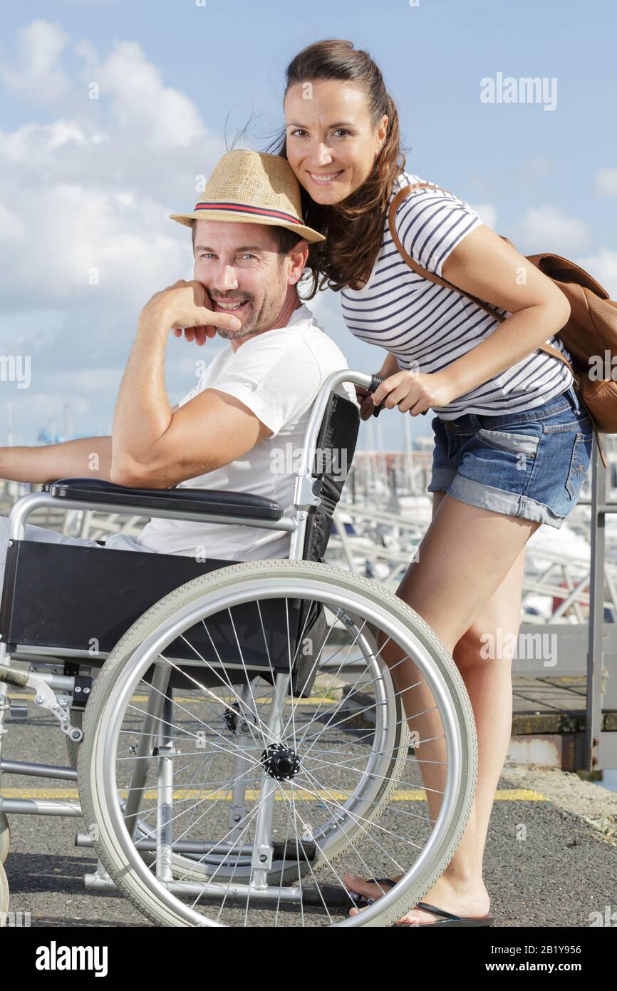 loving couple in wheelchair walking outdoors Stock Photo - Alamy