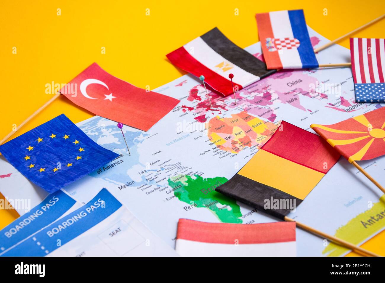 Flags from different countries and boarding pass over world map ...