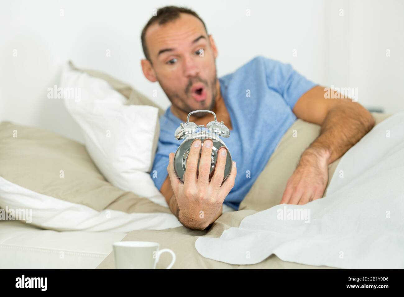 a man waking up late Stock Photo - Alamy