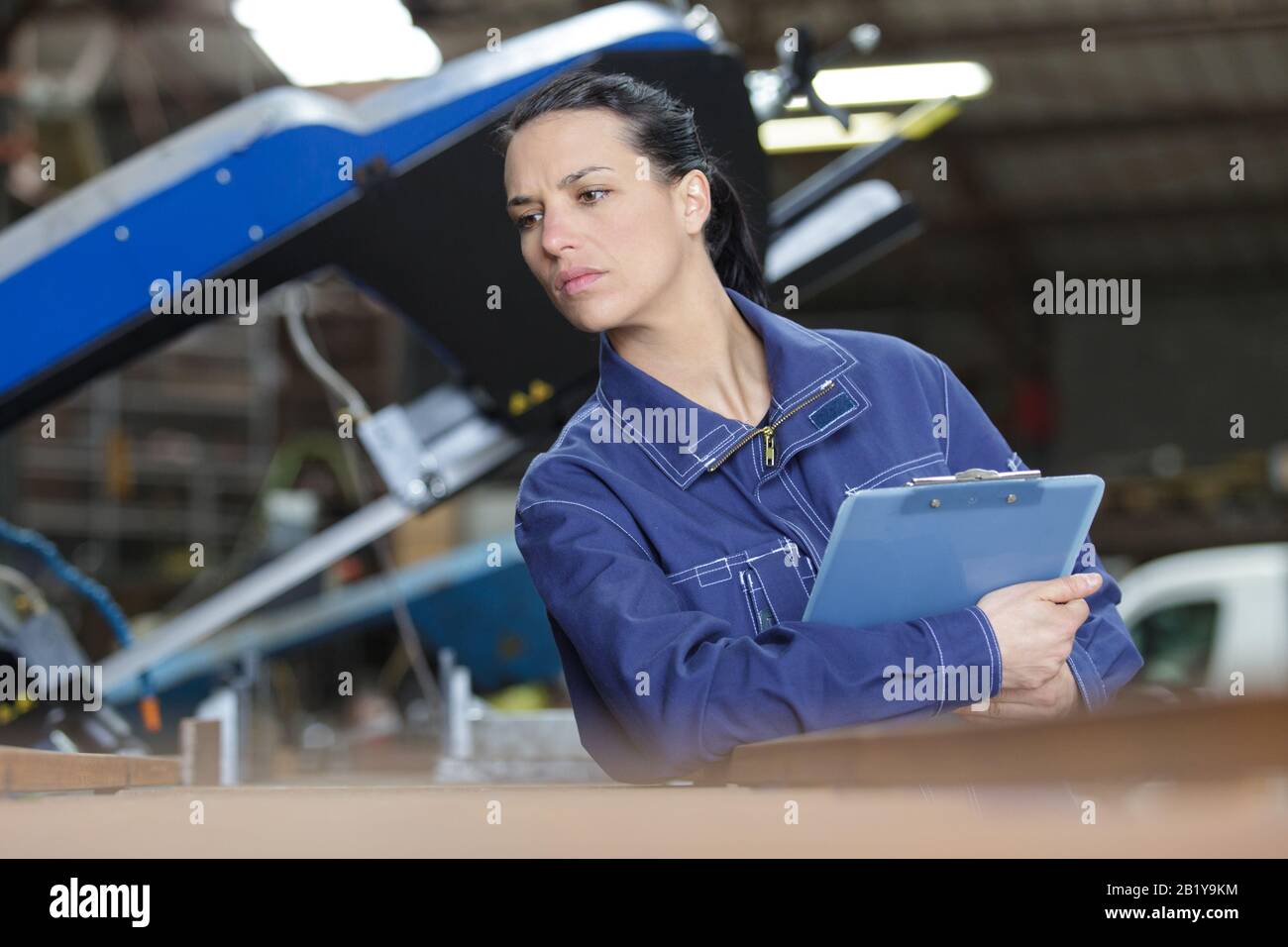 portrait of a female employee supervises and controls something Stock ...