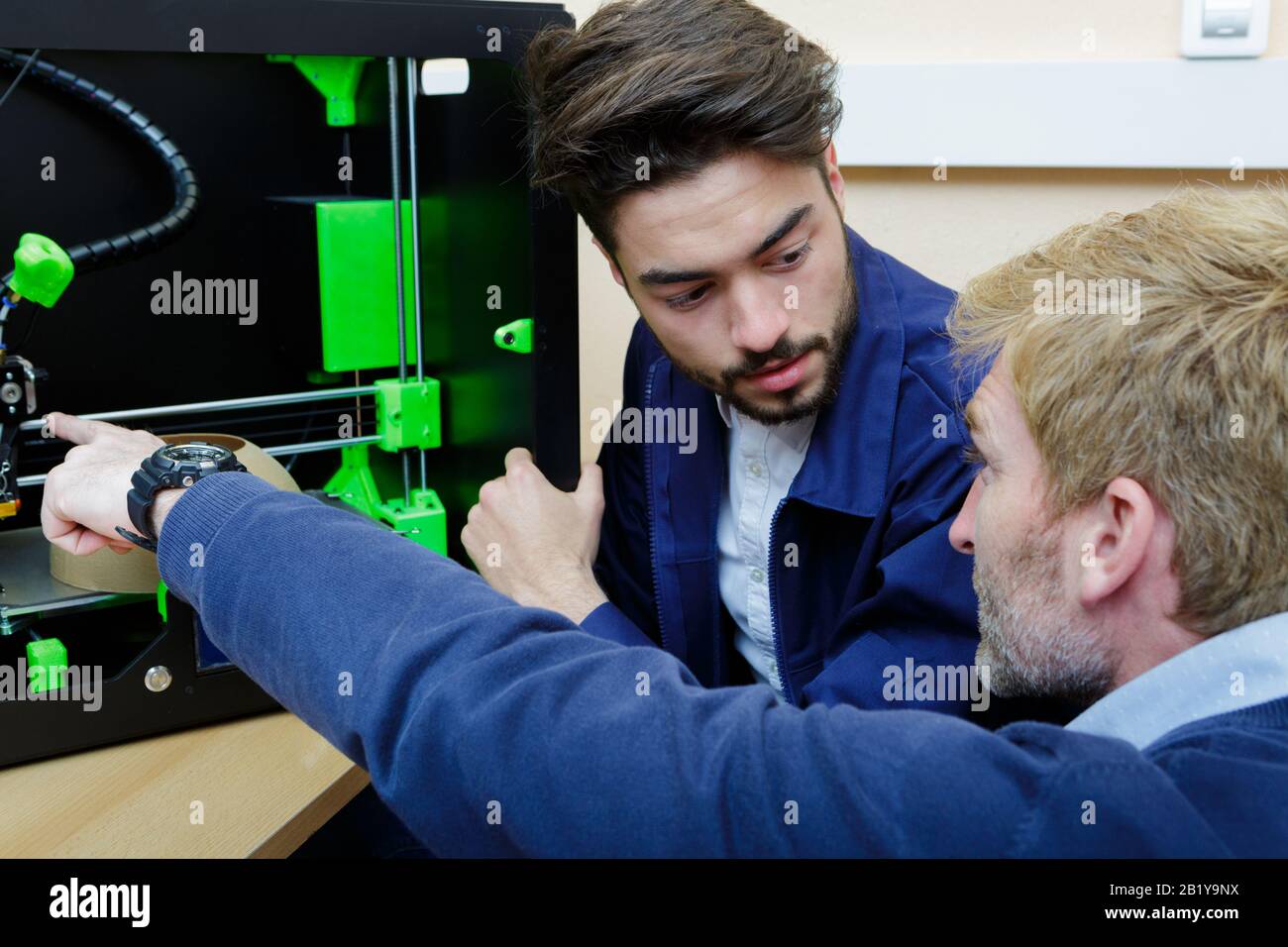 two engineers print the details on the 3d printer Stock Photo - Alamy