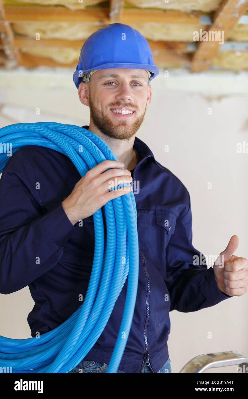 happy plumber showing thumb up Stock Photo - Alamy