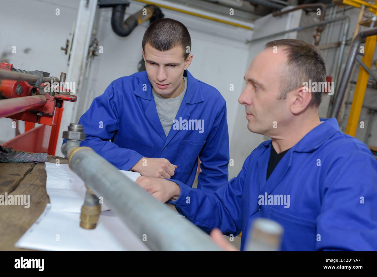 teacher with student in metallurgy workshop Stock Photo - Alamy