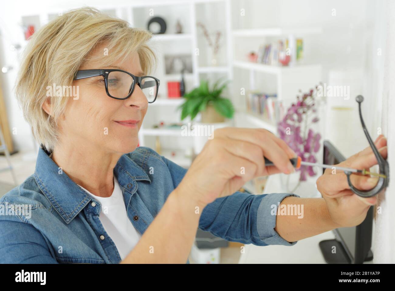 an old woman doing diy Stock Photo - Alamy
