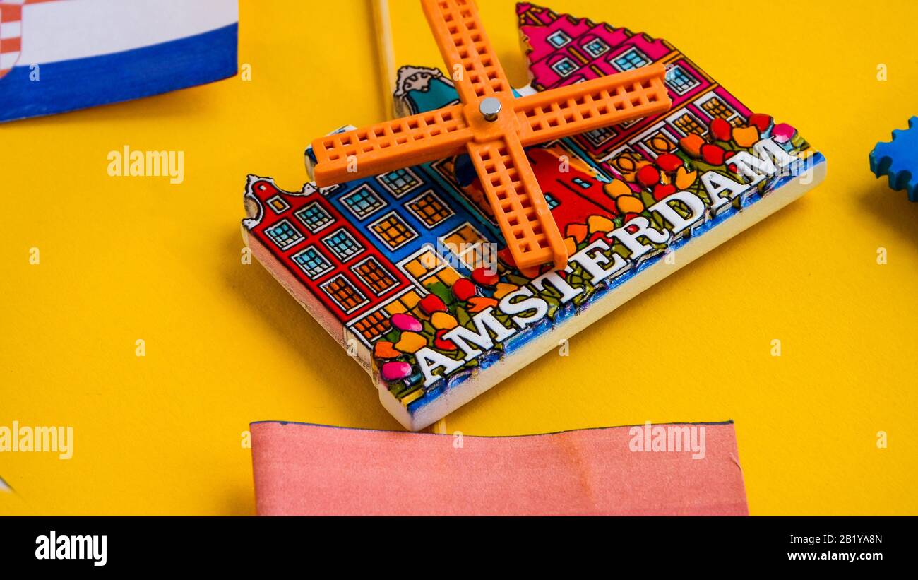 Netherlands travel concept, magnet from amsterdam and flag over world ...
