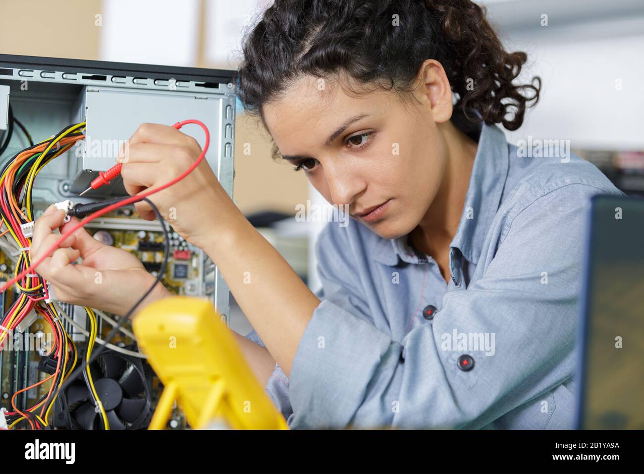 tech tests electronic equipment in service centre Stock Photo - Alamy