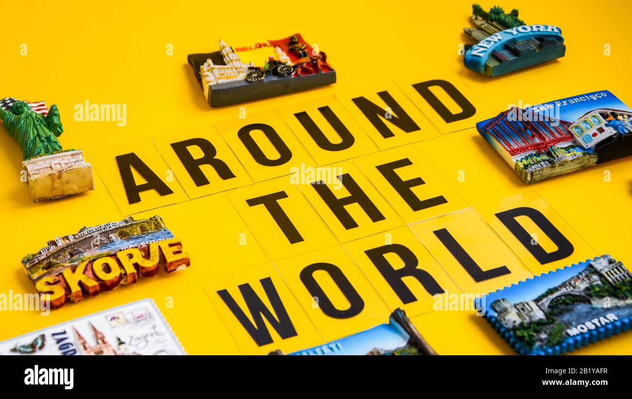 Text Around the world Magnets from different countries on yellow ...