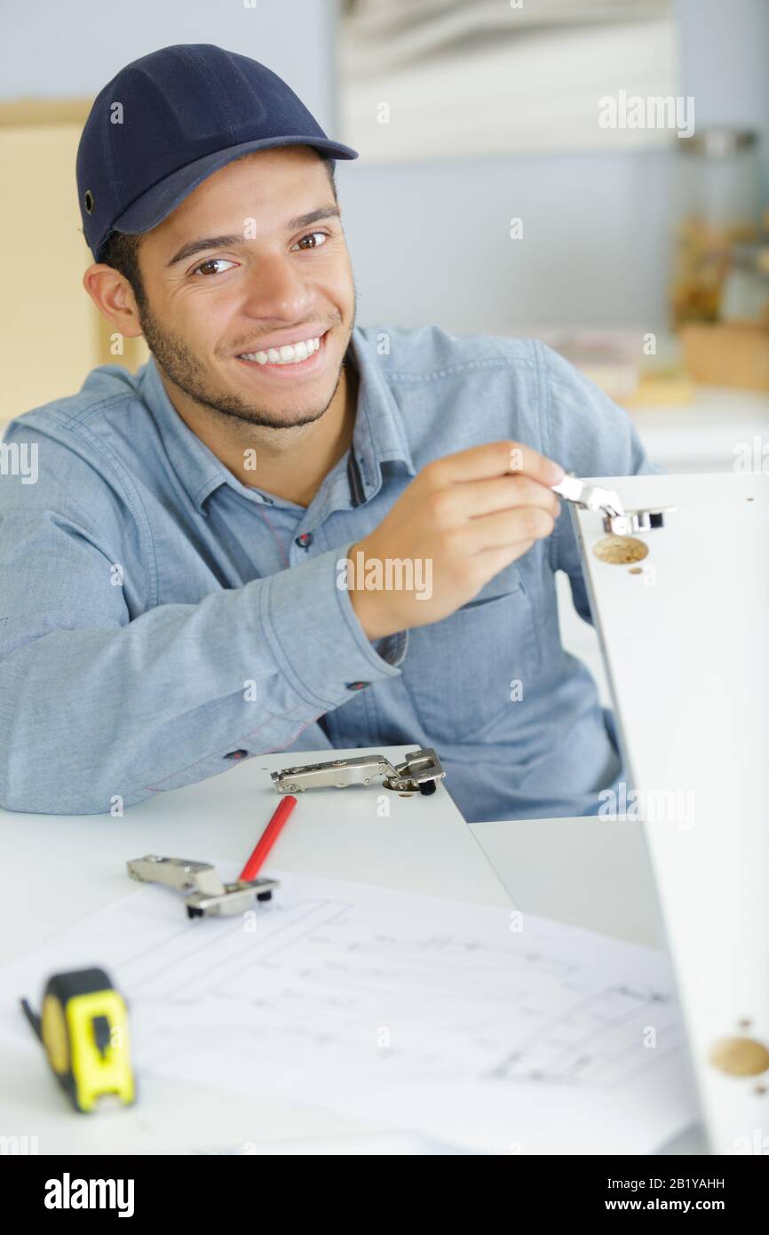 a young man assembling furniture Stock Photo - Alamy