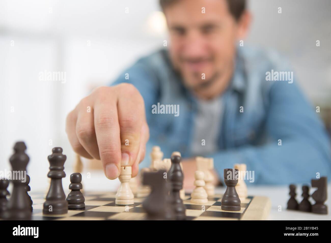 selective focus of focused young man playing chess Stock Photo - Alamy