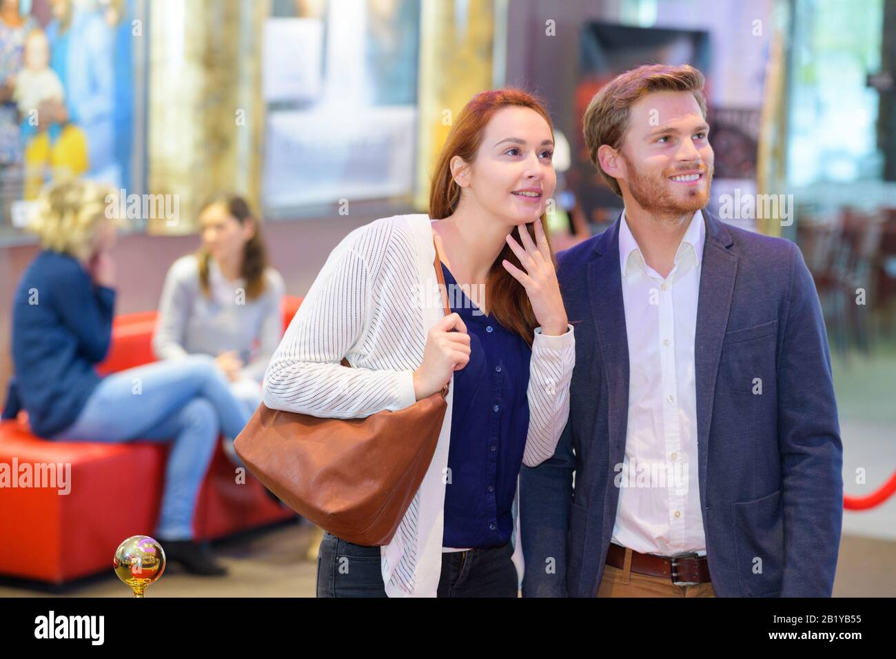 portrait of couple choosing a movie Stock Photo - Alamy