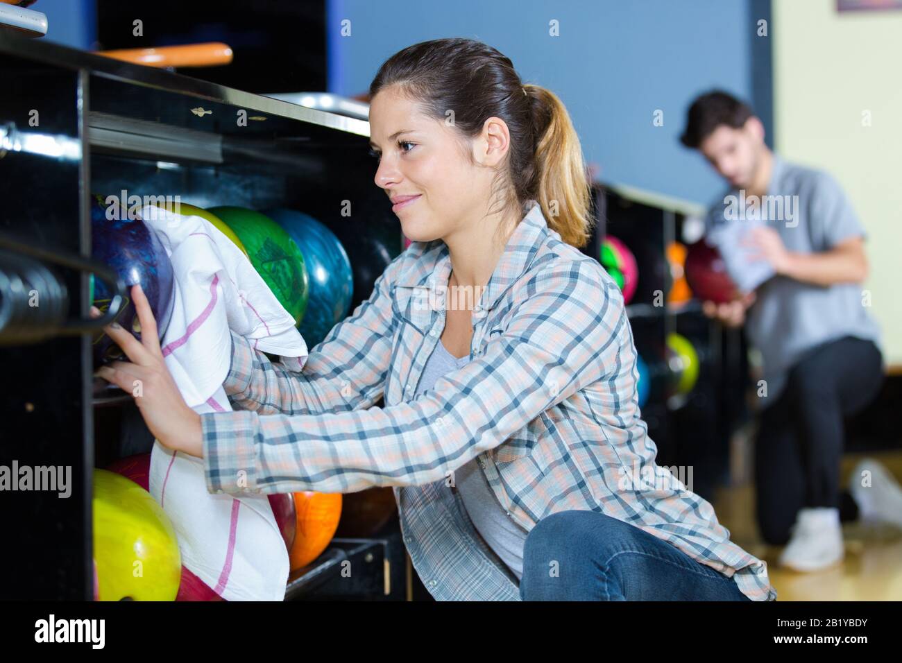 bowling workers cleaning balls Stock Photo - Alamy