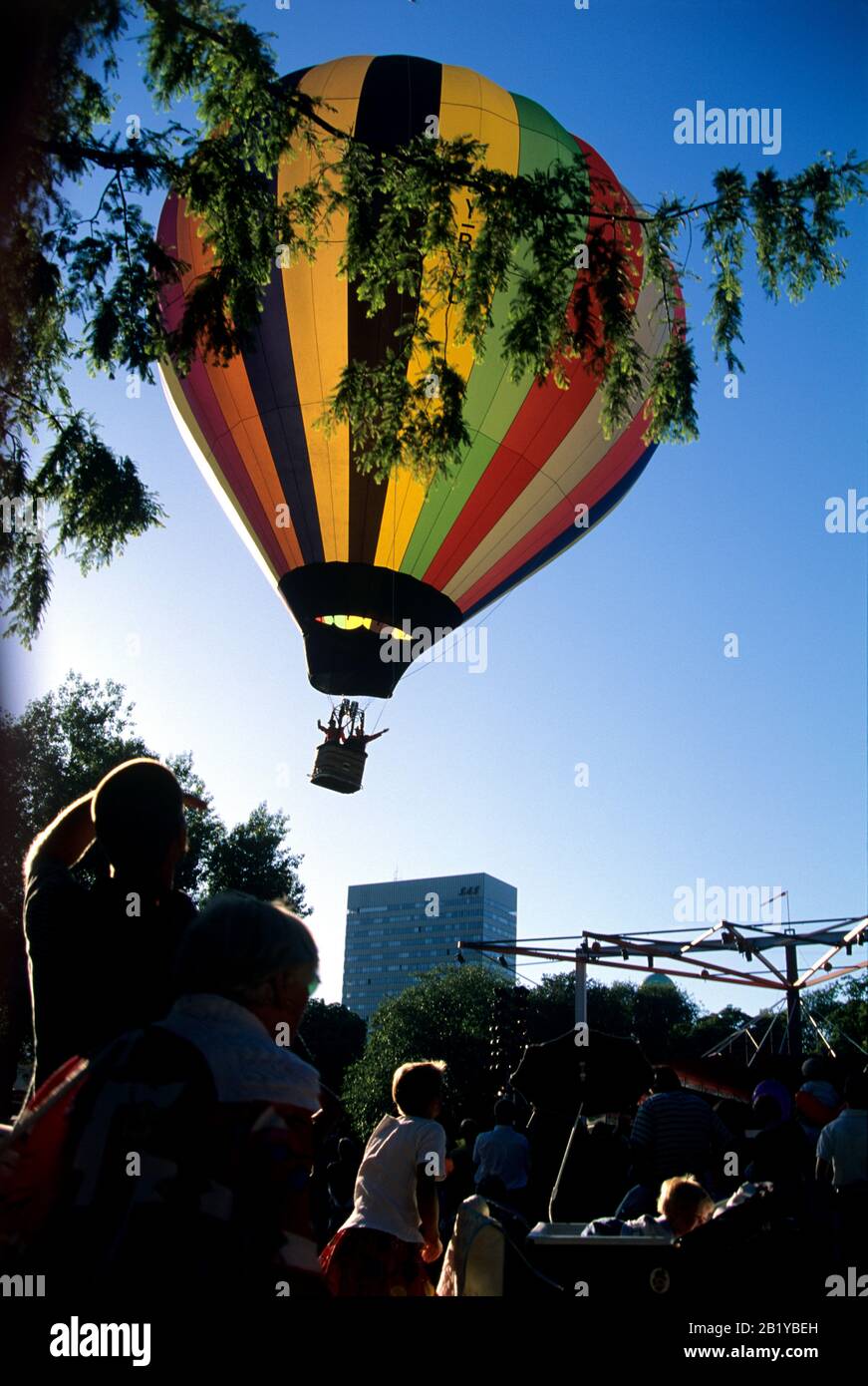Hot air ballon flying over fairground Stock Photo - Alamy