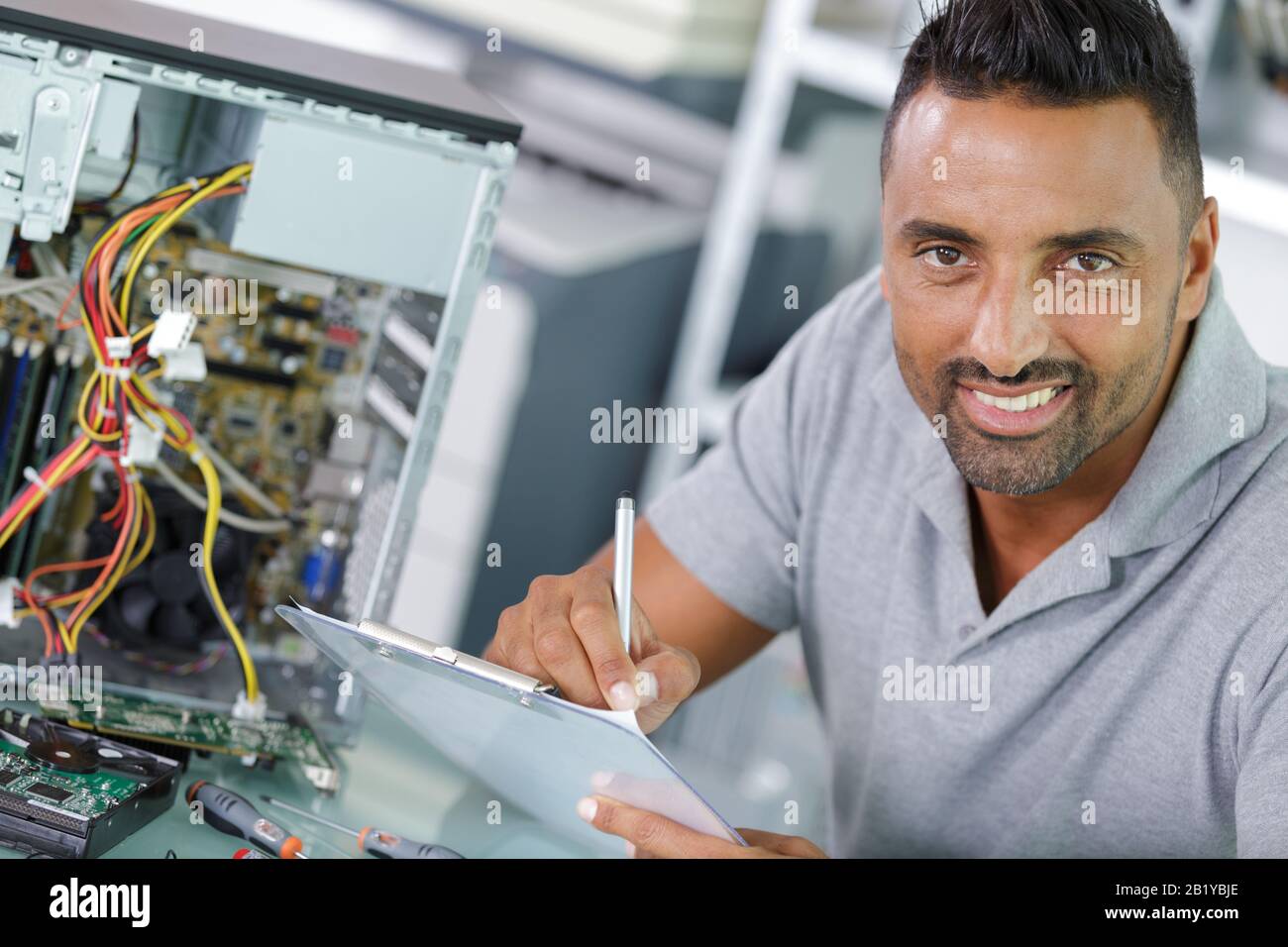 a male technician fixing cables Stock Photo - Alamy