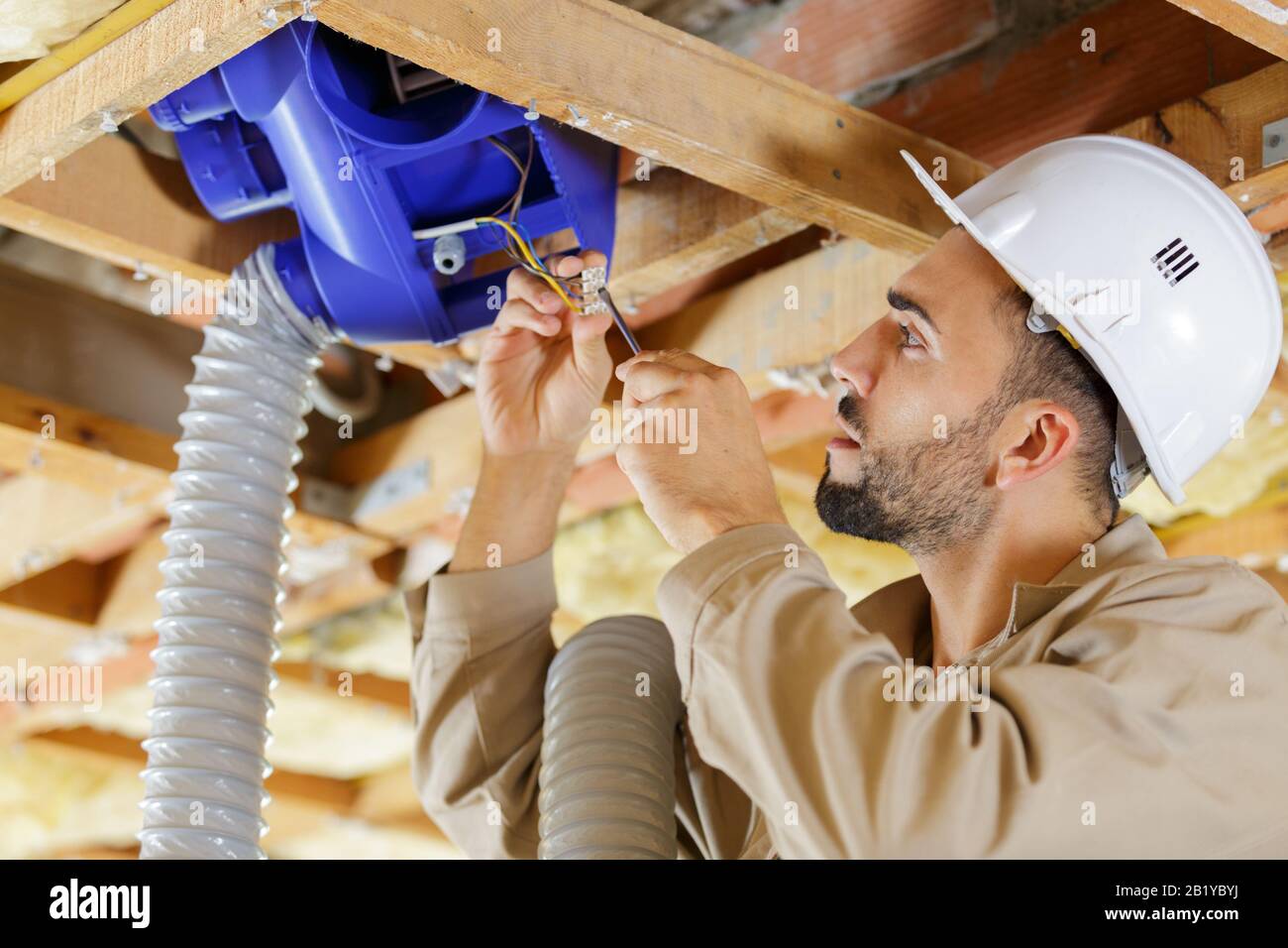 builder connecting wires on hvac unit Stock Photo - Alamy