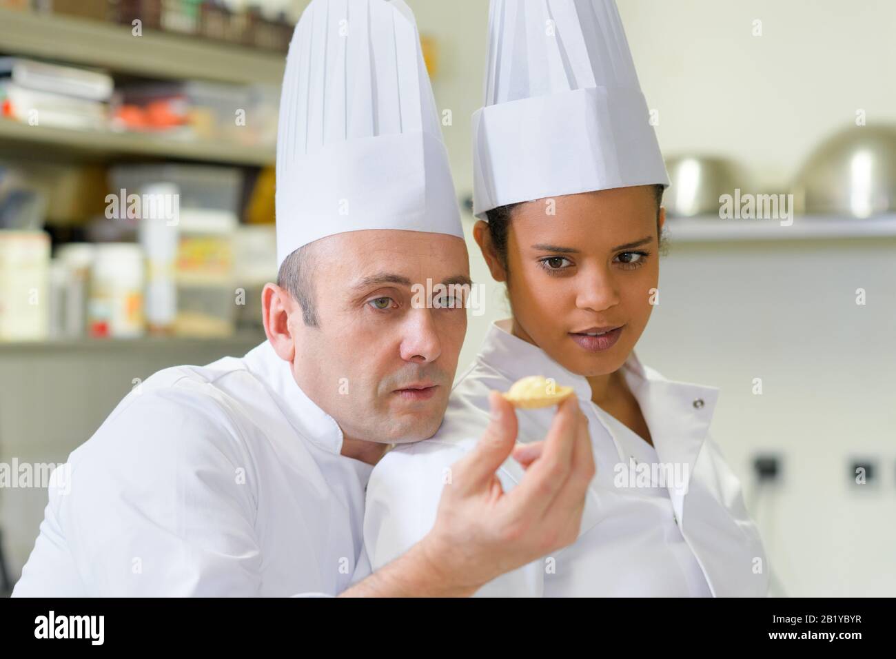 two bakers looks at pastries Stock Photo - Alamy