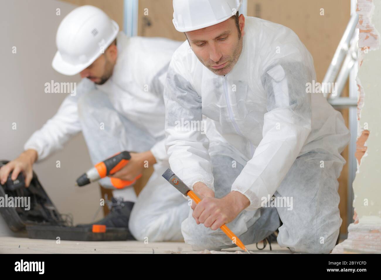 portrait of workman using chisel Stock Photo - Alamy