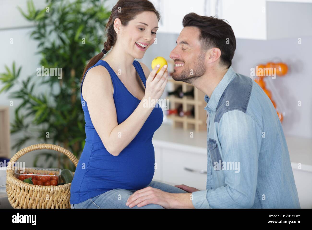 young woman feeding lemon to boyfriend Stock Photo - Alamy