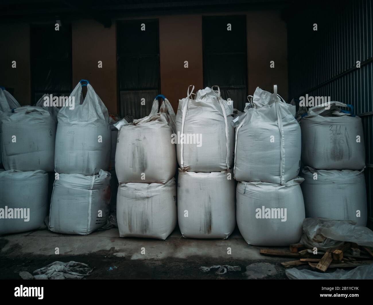 White polyethylene bags with factory products in warehouse Stock Photo ...