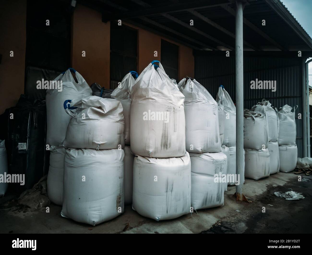 White polyethylene bags with factory products in warehouse Stock Photo ...