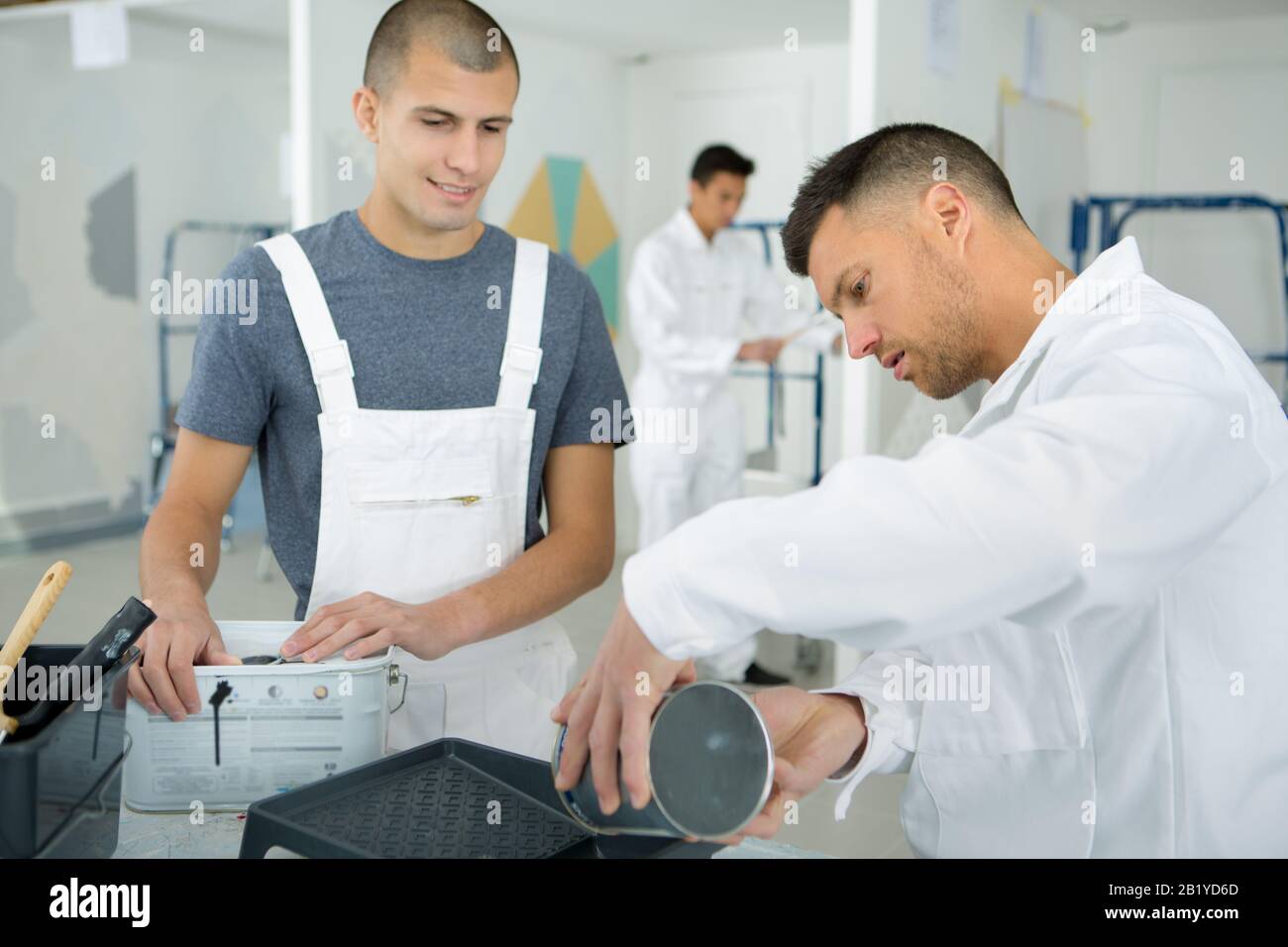 man pouring paint into tray Stock Photo - Alamy