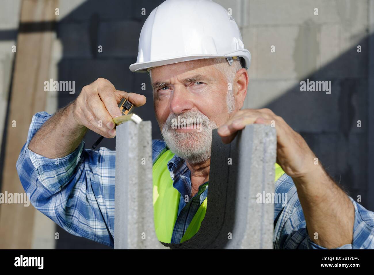 senior male construction engineer measuring concrete block Stock Photo ...