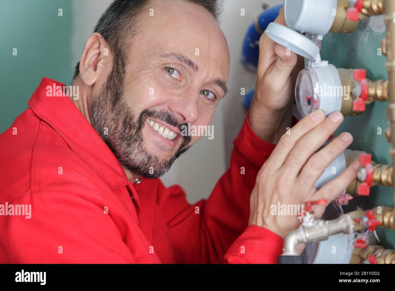 male plumber fixing water meter with adjustable wrench Stock Photo - Alamy