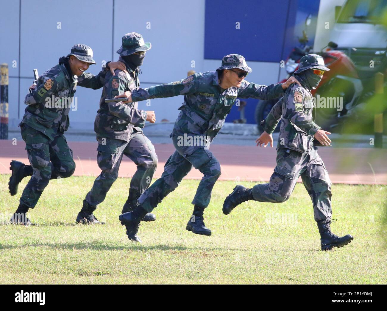 In-service policemen pointing their service firearm during VIP Security ...