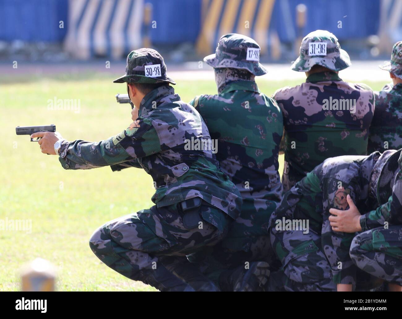 In-service policemen pointing their service firearm during VIP Security ...