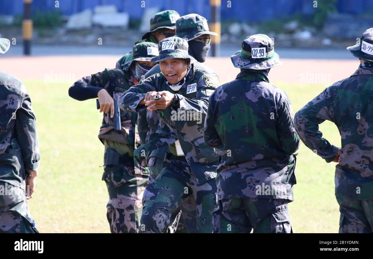 In-service policemen pointing their service weapon while on maneuver ...