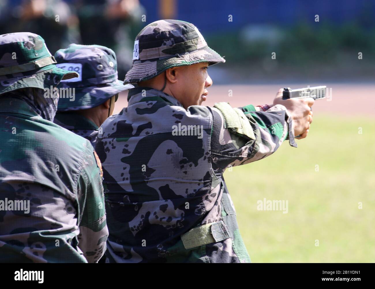 In-service policemen pointing their service weapon while on maneuver ...