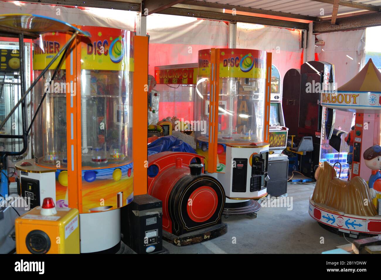 Amusement park funfair rides and vintage slot machines with vibrant ...