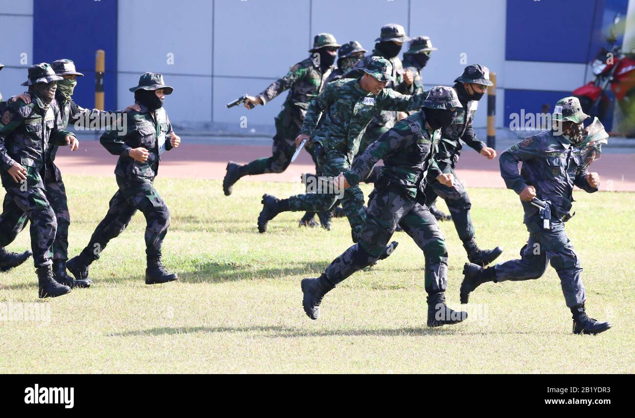 In-service policemen pointing their service firearm during VIP Security ...