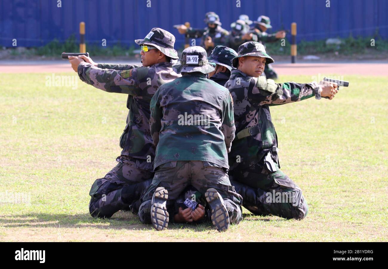 In-service policemen pointing their service firearm during VIP Security ...