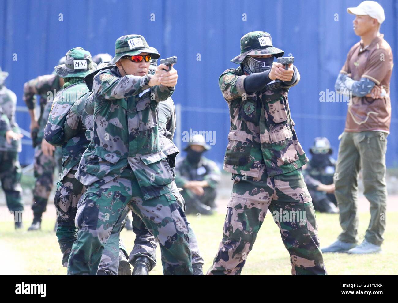 In-service policemen pointing their service weapon during VIP Security ...