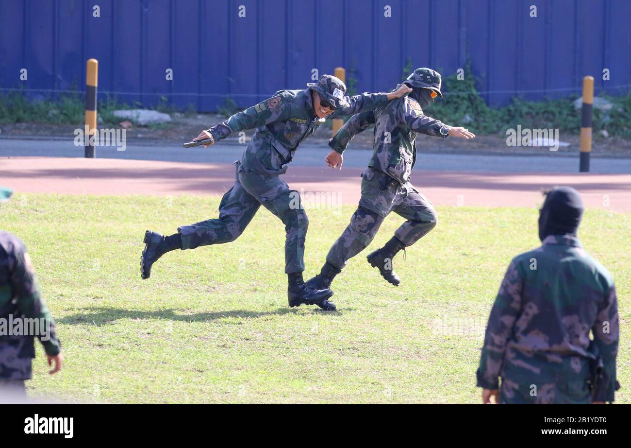 In-service policemen pointing their service weapon while on maneuver ...