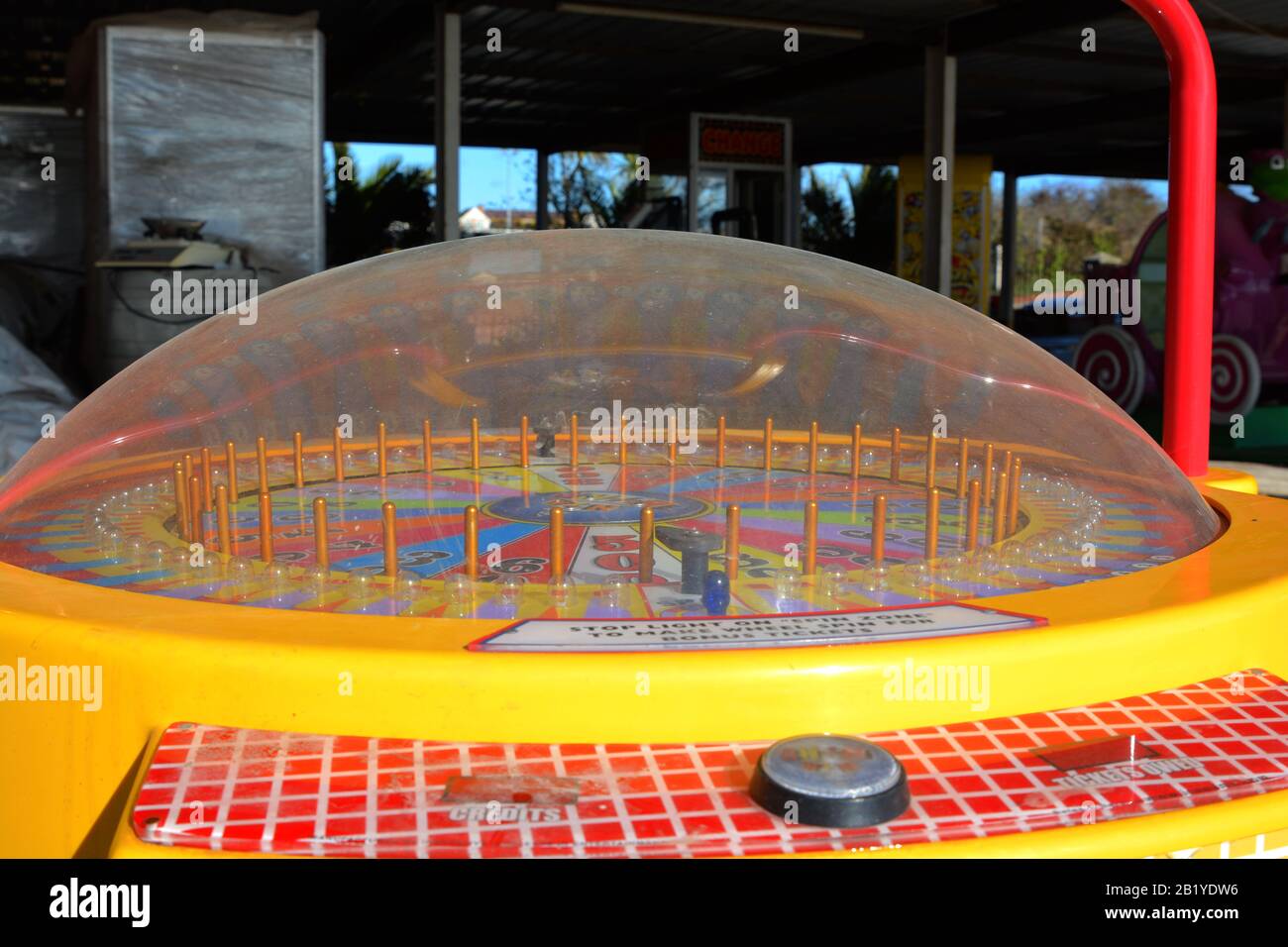 Amusement park funfair rides and vintage slot machines with vibrant ...