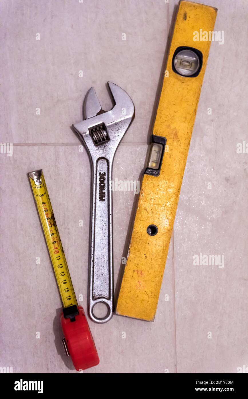 set of hand working tools on ceramic tile background The concept of ...