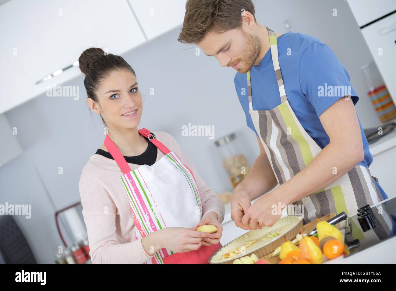 beautiful couple in the kitchen a cake Stock Photo - Alamy