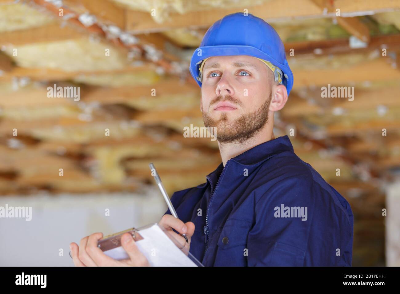 serious architect or engineer taking notes on a clipboard Stock Photo ...