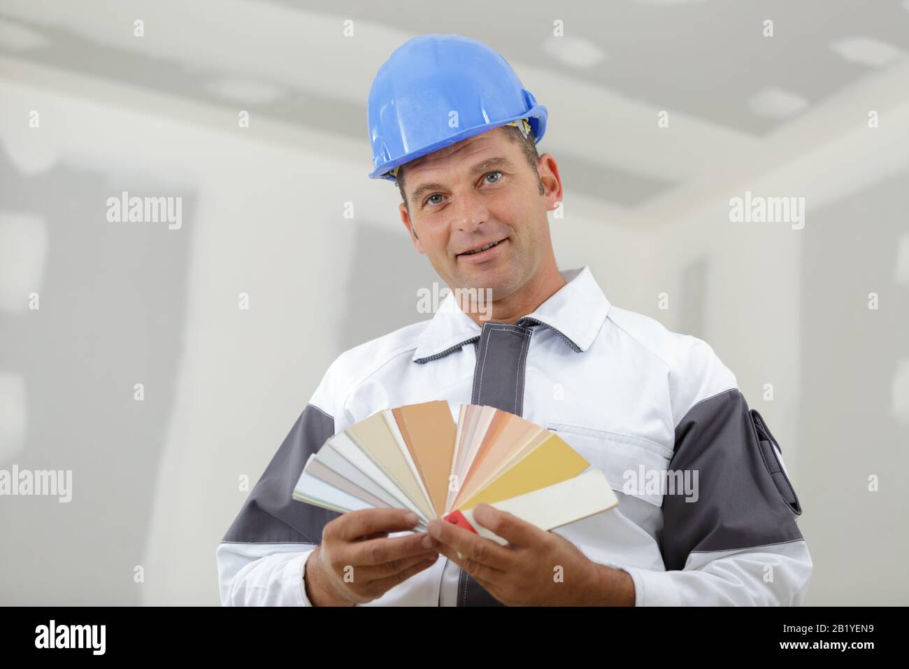 man builder holding a color swatch Stock Photo - Alamy